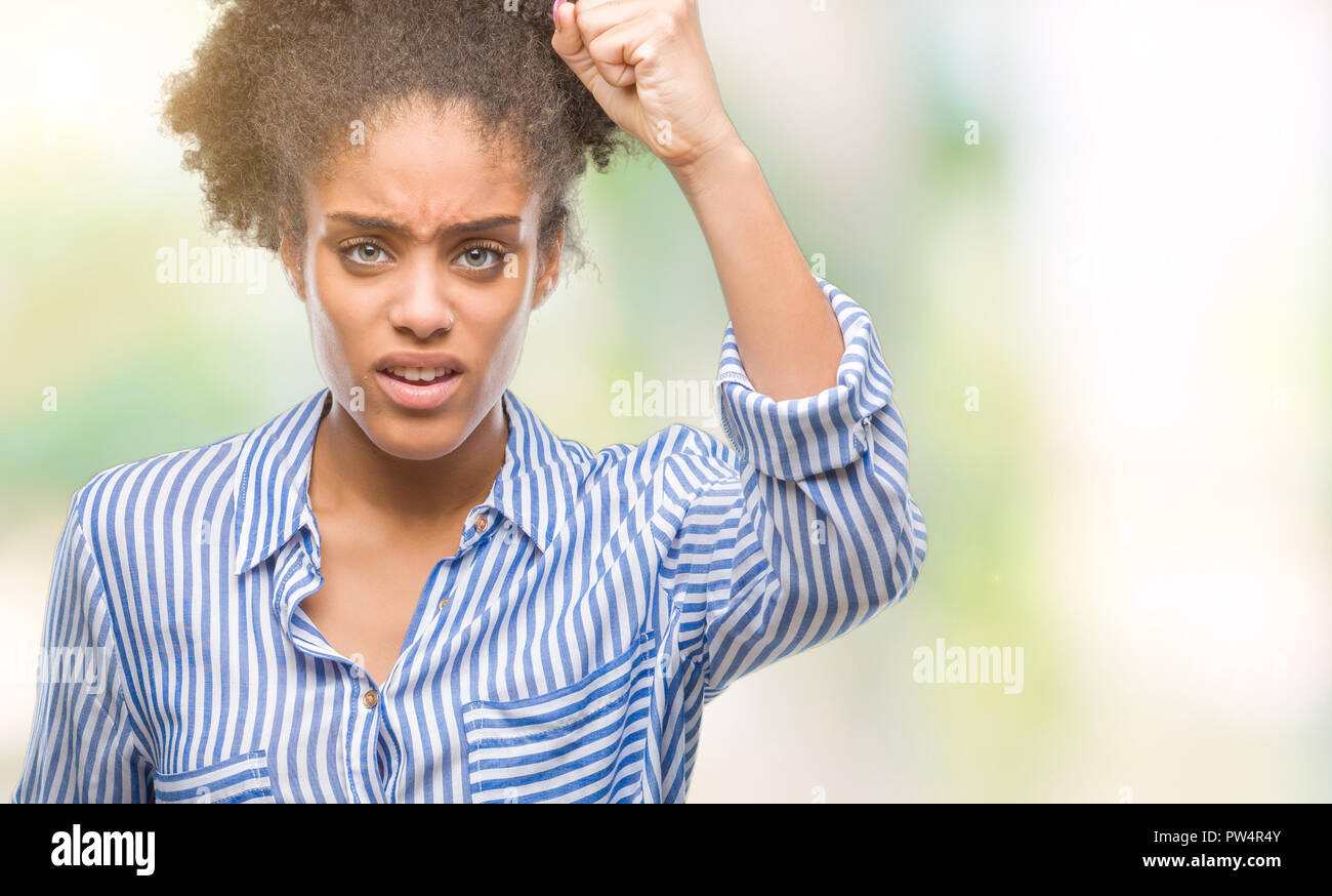 Young afro american woman over isolated background angry and mad ...