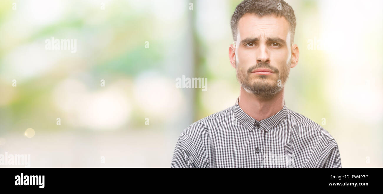 Young hipster man depressed and worry for distress, crying angry and ...