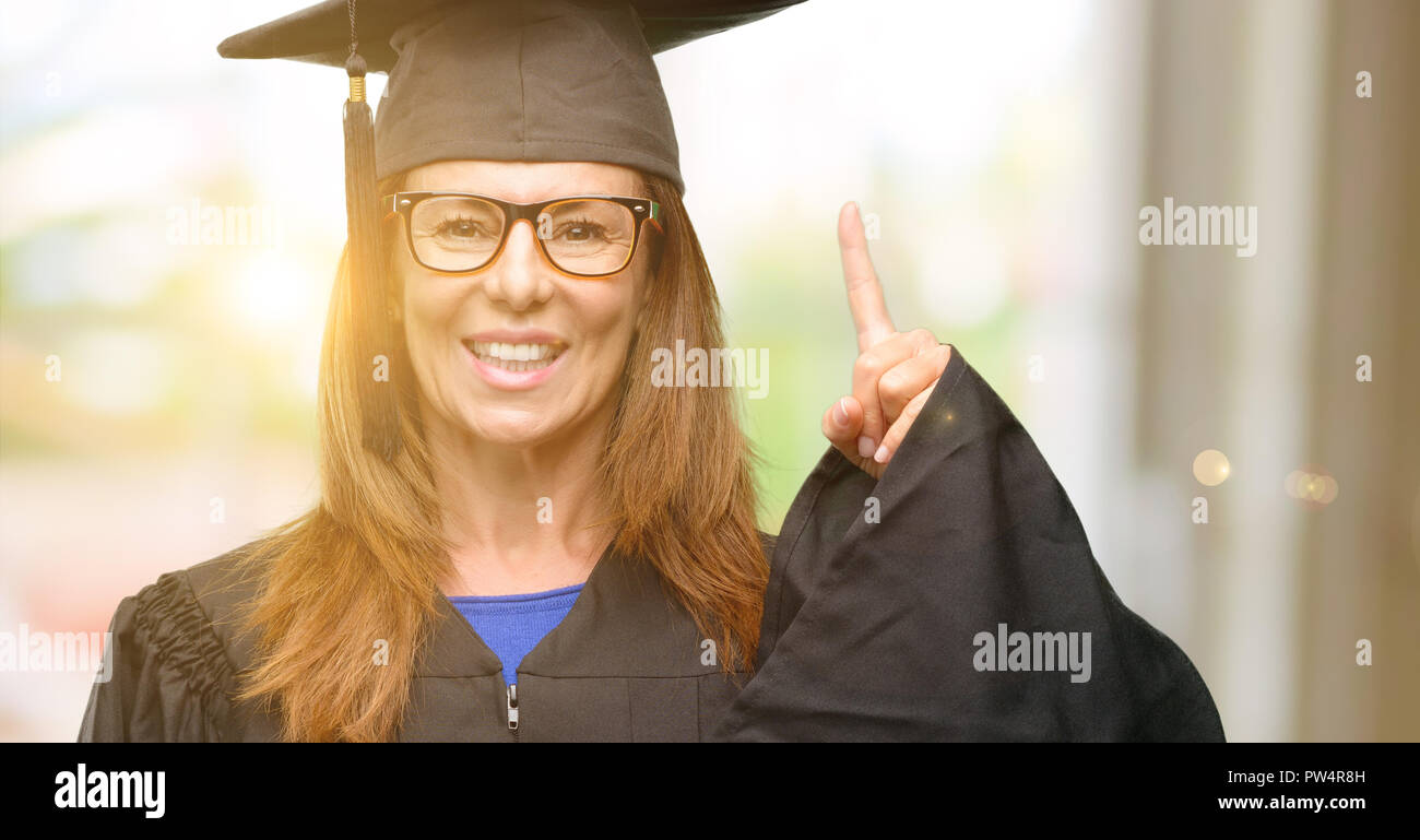 Senior graduate student woman raising finger, the number one Stock ...