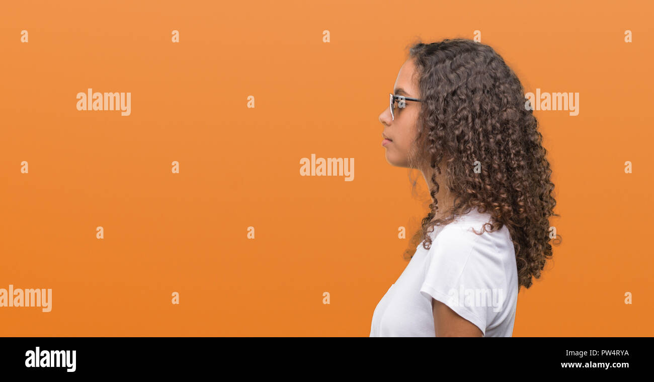 Young hispanic woman wearing sunglasses looking to side, relax profile ...