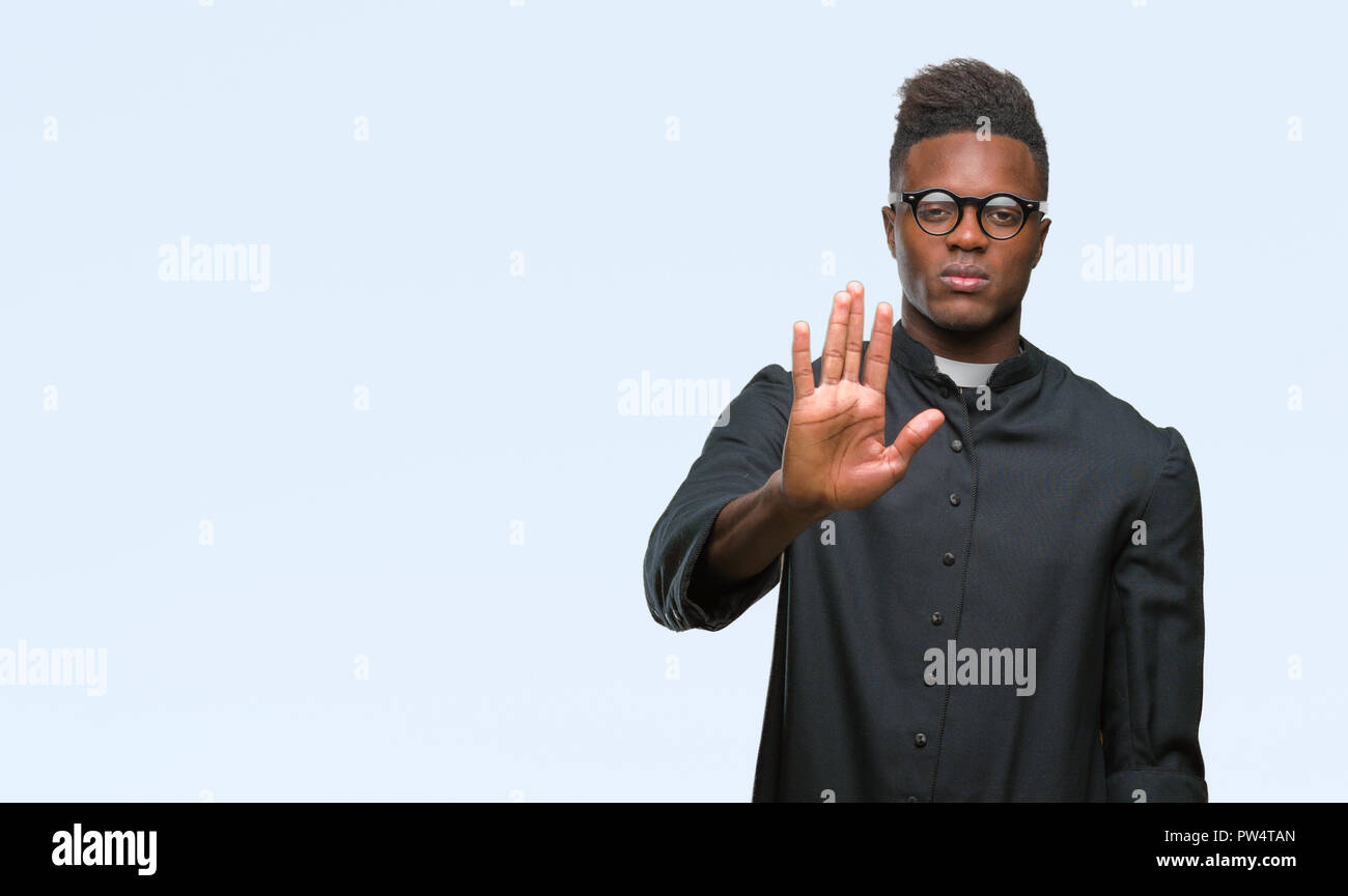 Young african american priest man over isolated background doing stop ...