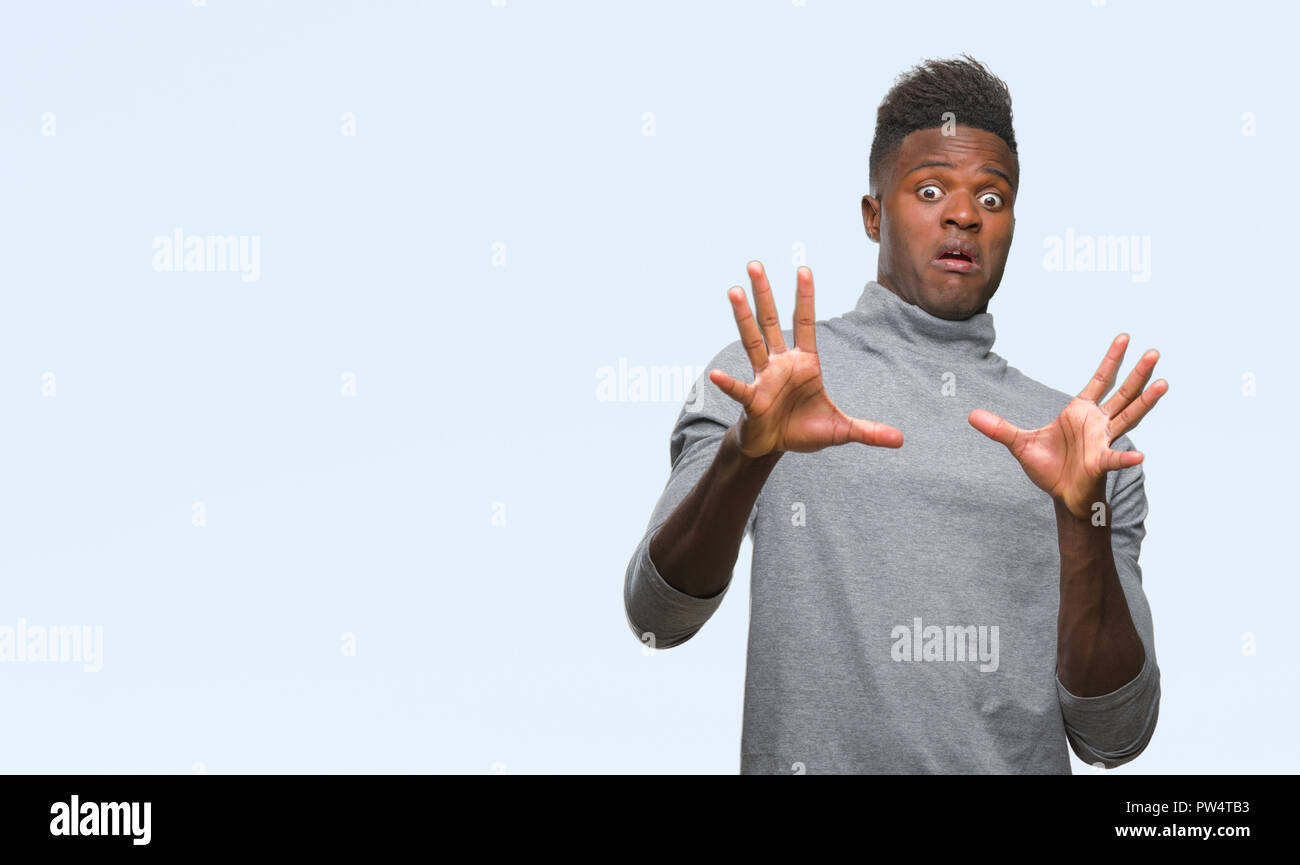 Young african american man over isolated background afraid and ...