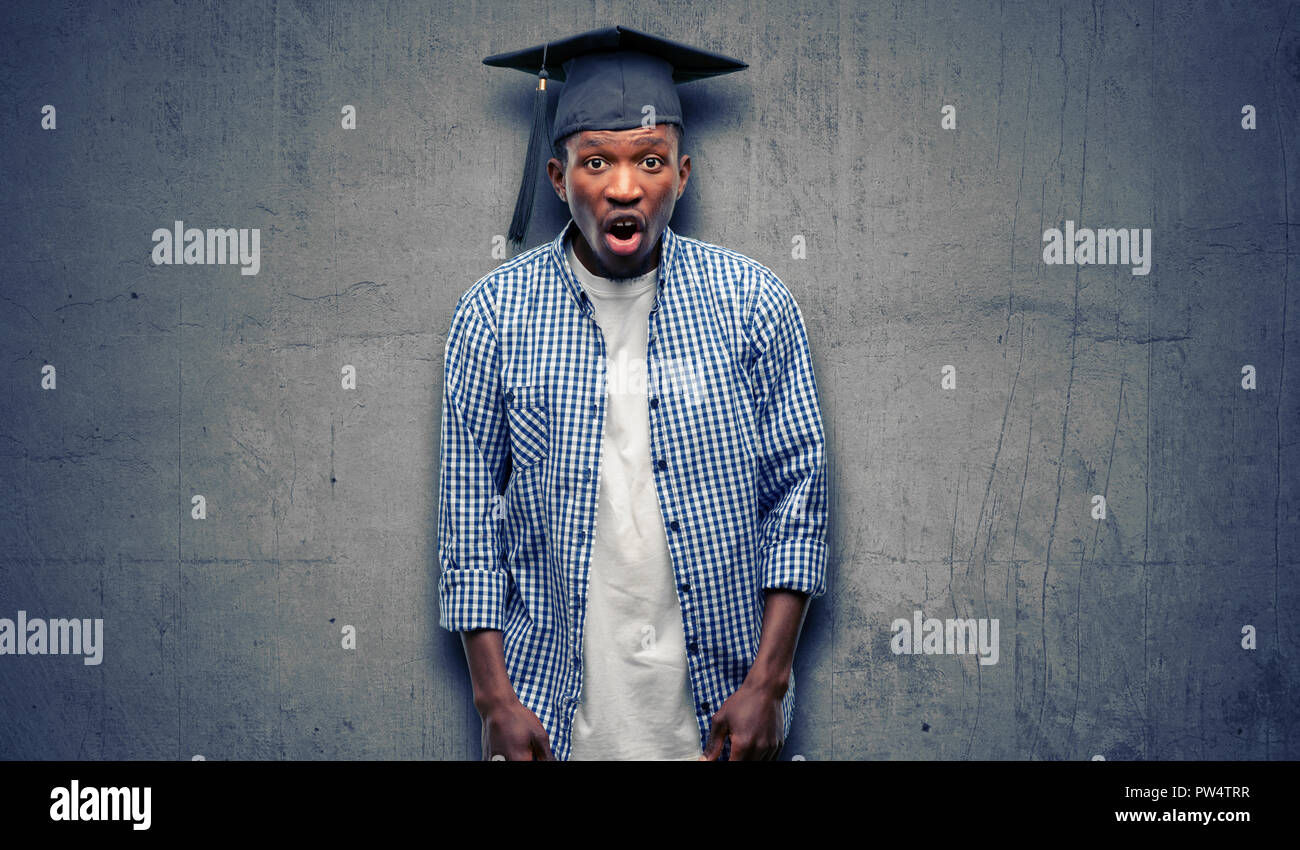 Young african graduate student black man scared in shock, expressing ...