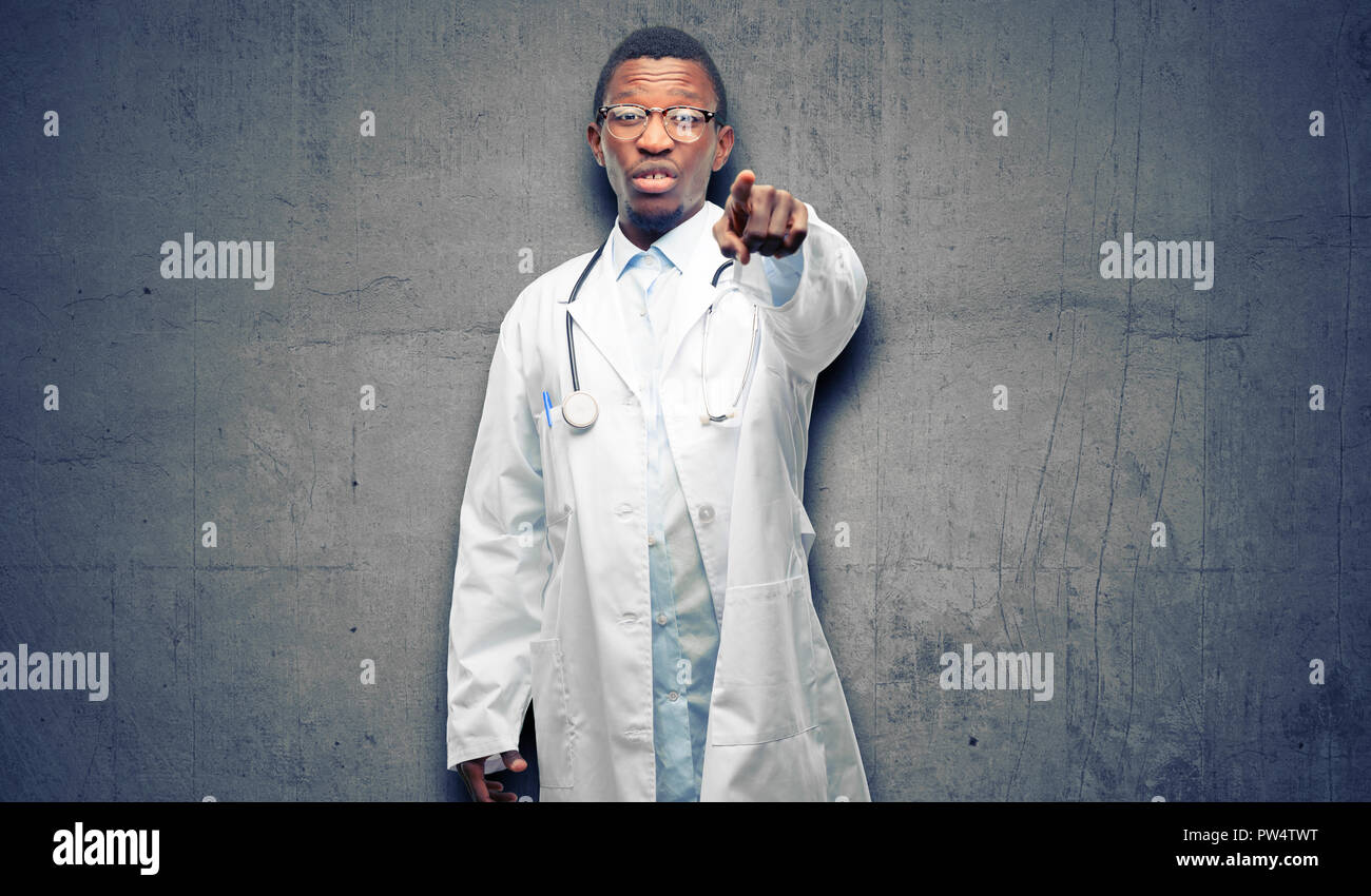 Young black doctor, medical professional pointing to the front with ...