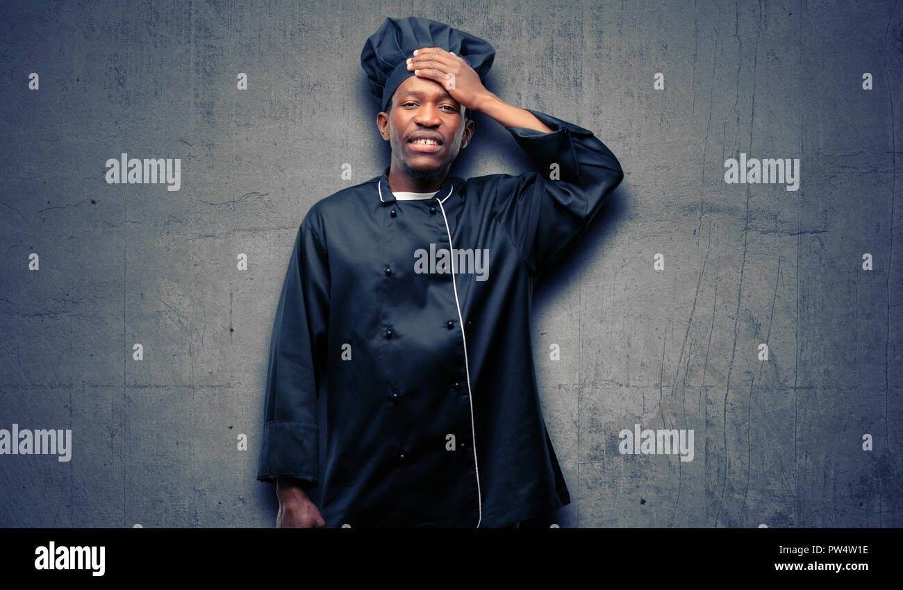 Young black cook wearing chef hat terrified and nervous expressing ...
