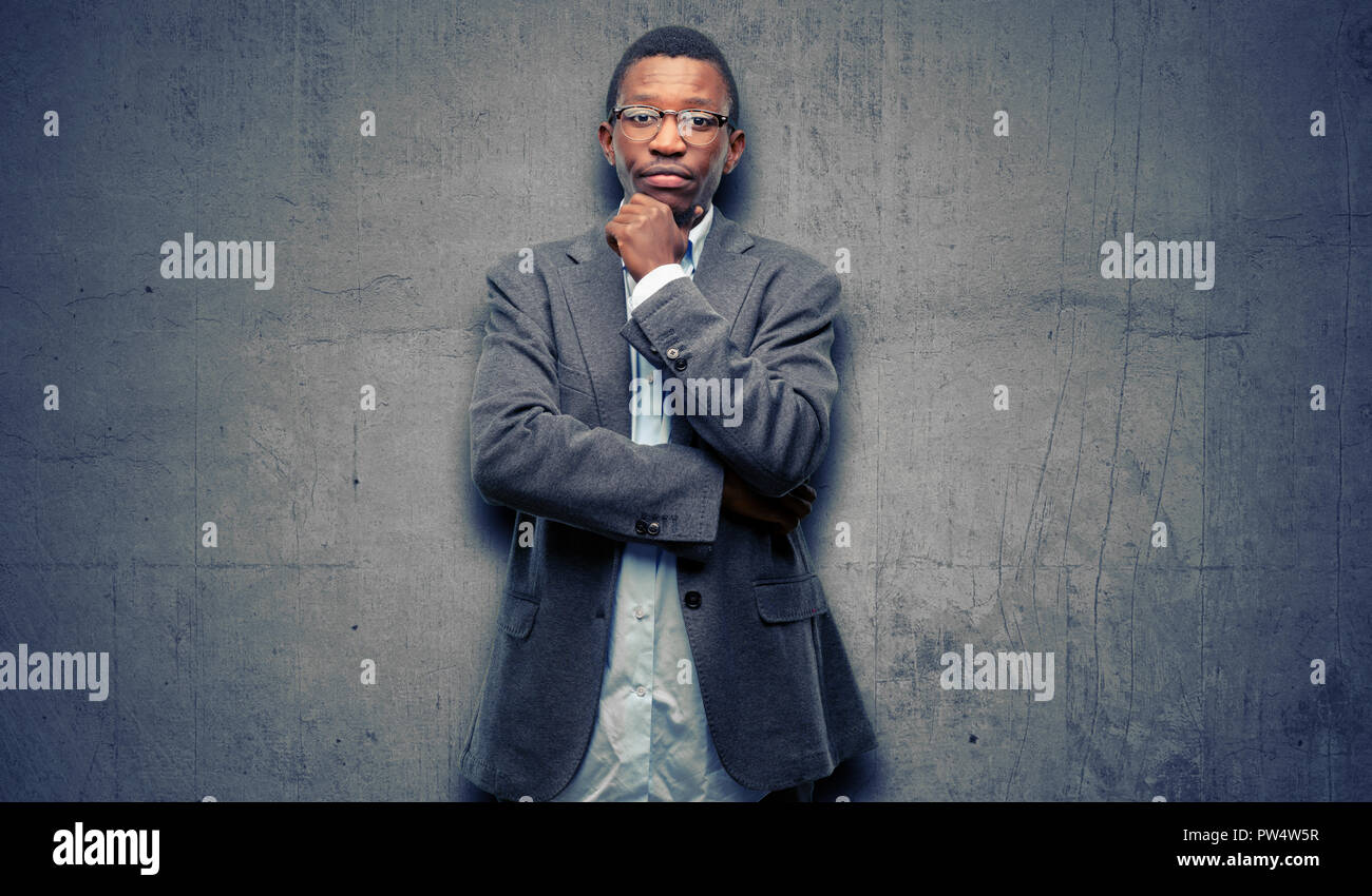 African black man wearing jacket thinking and looking up expressing ...