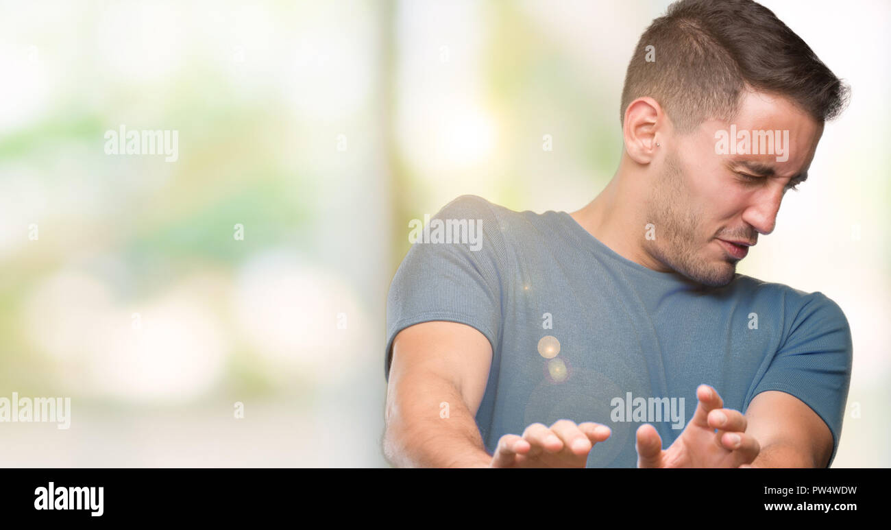 Handsome young casual man disgusted expression, displeased and fearful ...