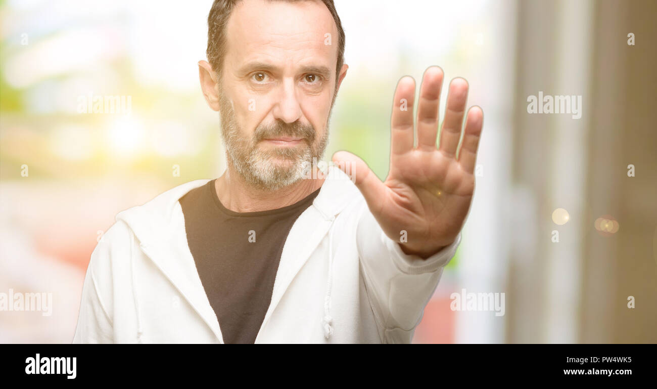 Middle age man wearing sportswear annoyed with bad attitude making stop ...