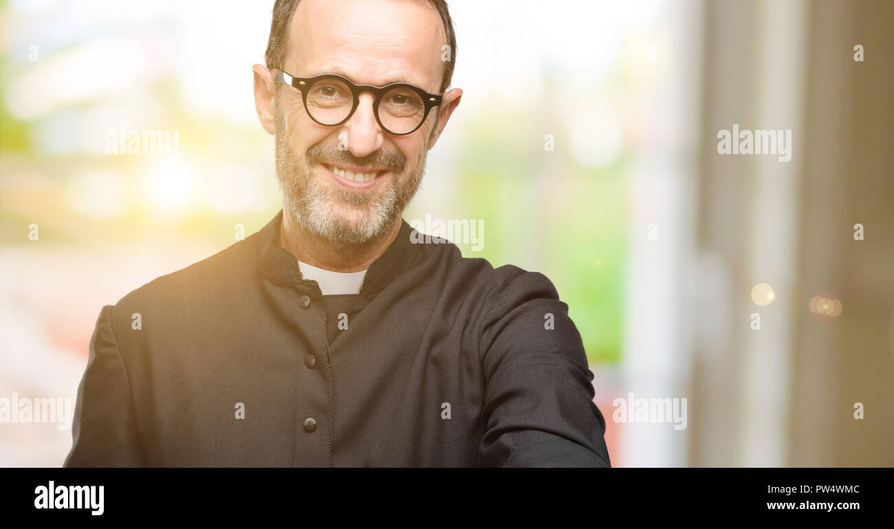 Priest catholic shaking hands hi-res stock photography and images - Alamy