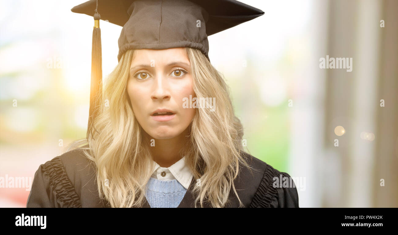 Young graduate woman scared in shock, expressing panic and fear Stock ...