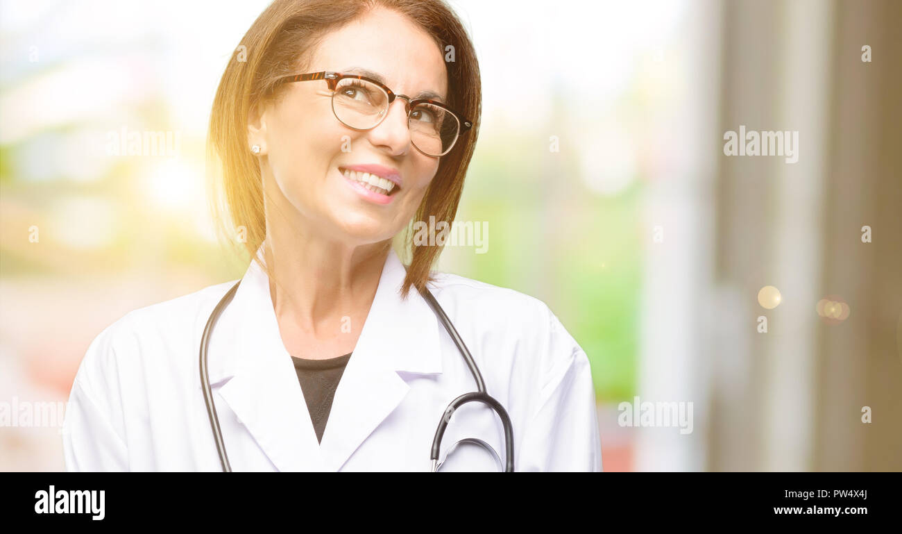 Doctor woman, medical professional thinking and looking up expressing ...