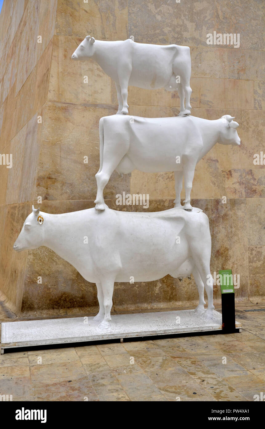 A sculpture of three cows on top of each other in the Maltese capital ...