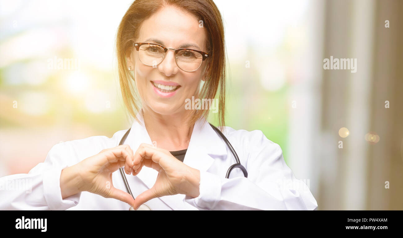 Doctor woman, medical professional happy showing love with hands in ...