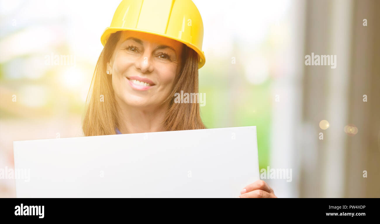 Engineer construction worker woman holding blank advertising banner ...