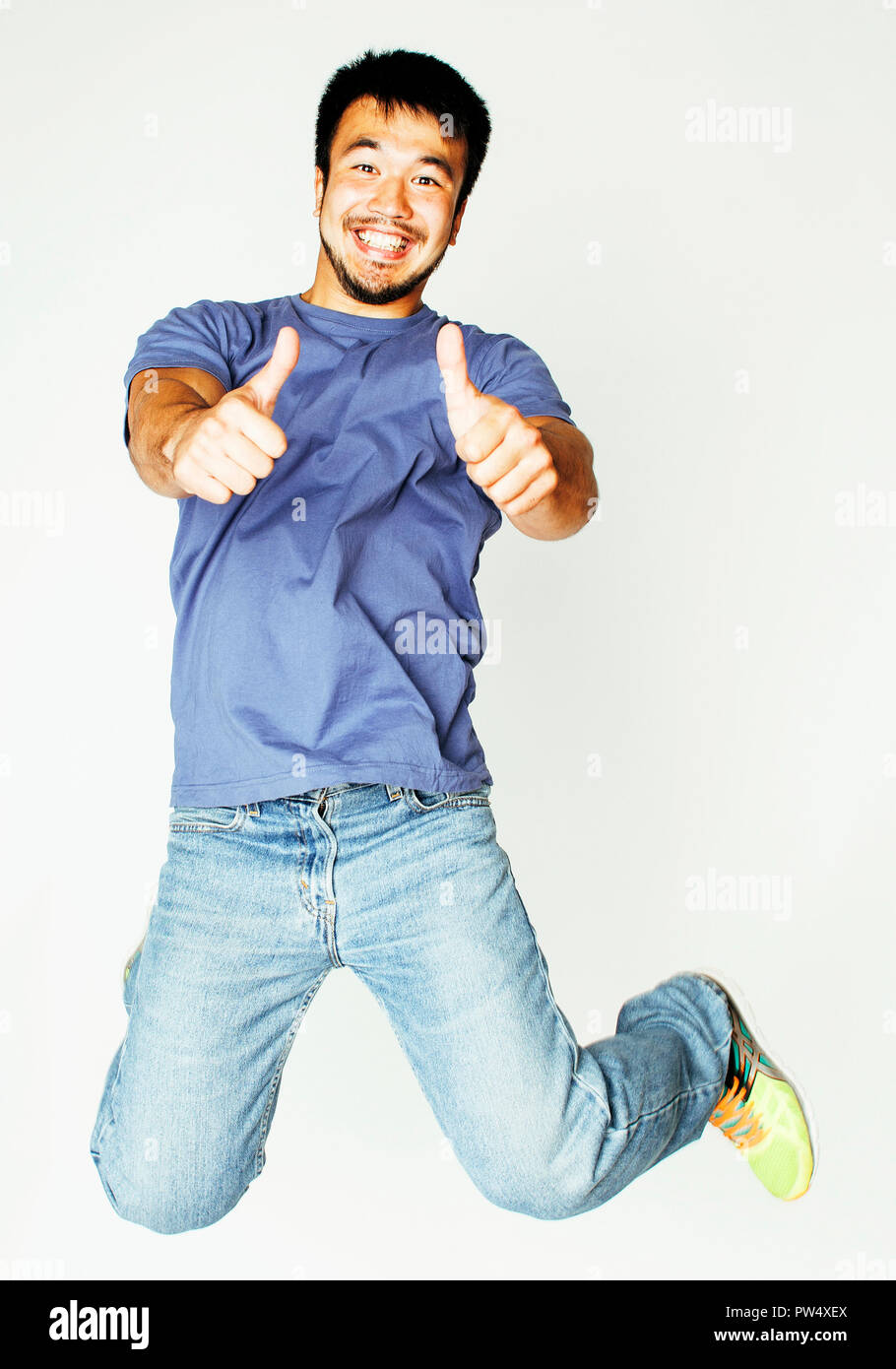 young pretty asian man jumping cheerful against white background Stock ...