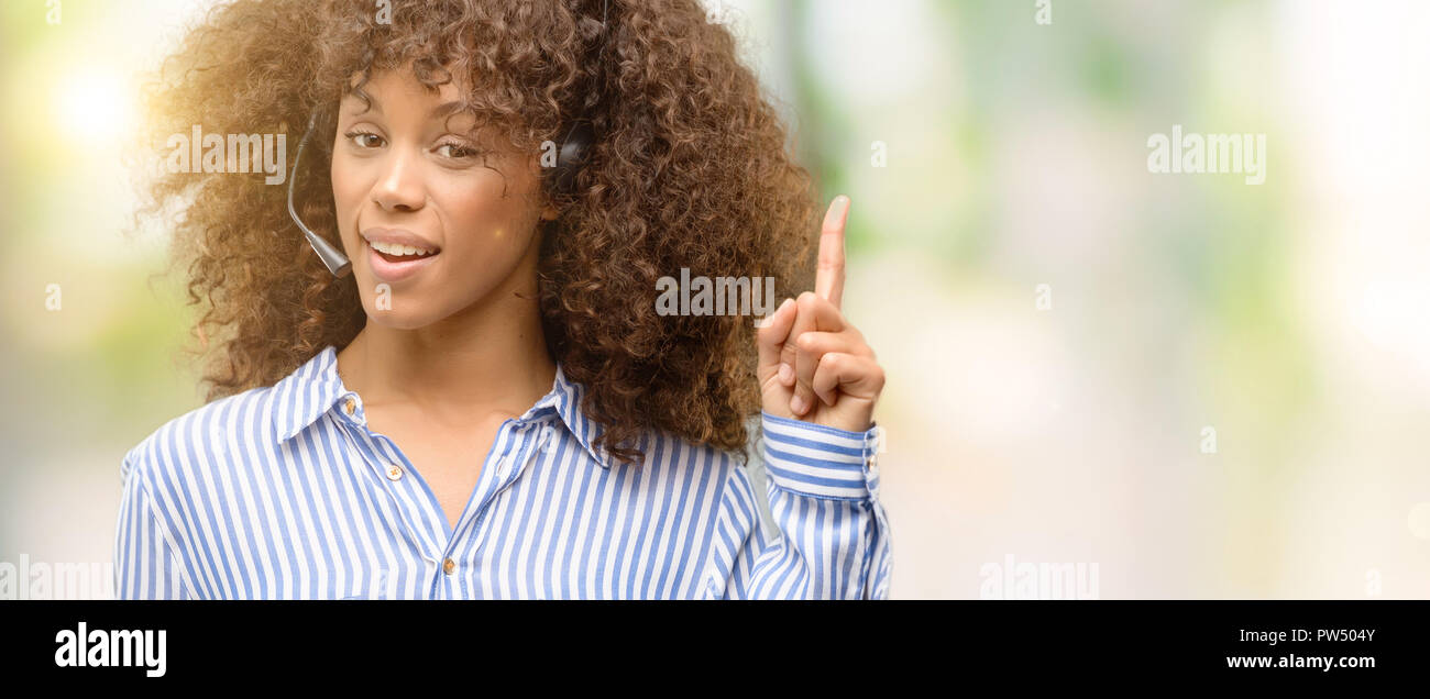 African american call center operator woman surprised with an idea or ...