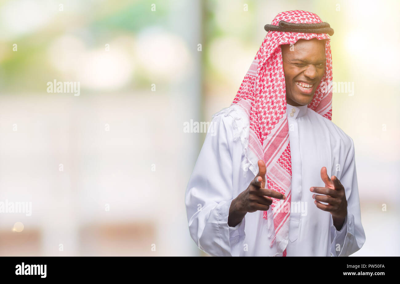 Young arabic african man wearing traditional keffiyeh over isolated ...