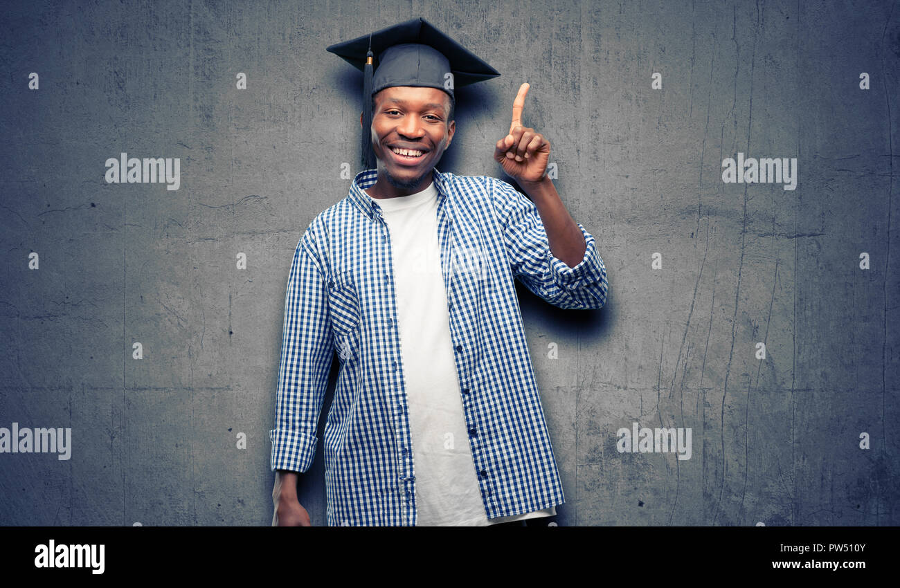 Young african graduate student black man pointing away side with finger ...