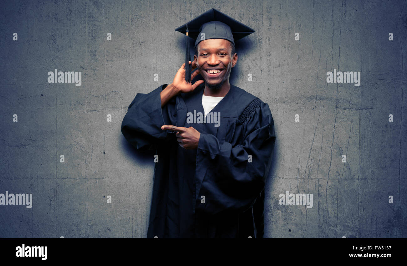Young african graduate student black man pointing away side with finger ...