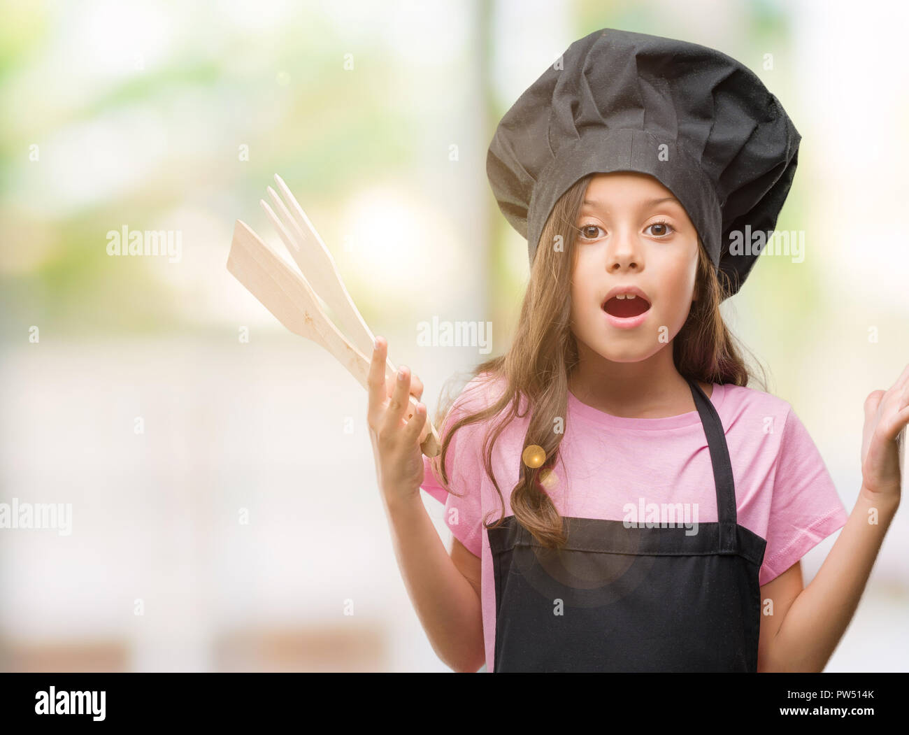 Brunette hispanic girl wearing cook uniform very happy and excited ...