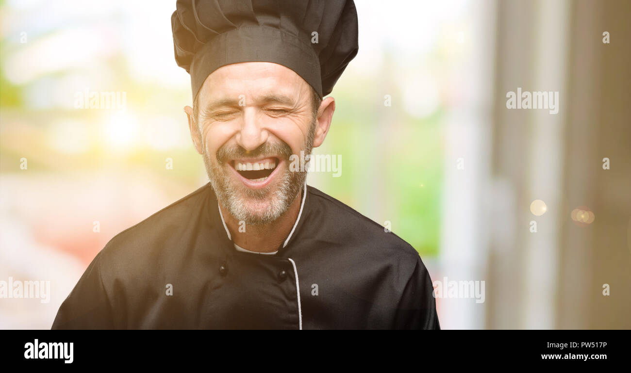 Senior cook man, wearing chef hat confident and happy with a big ...