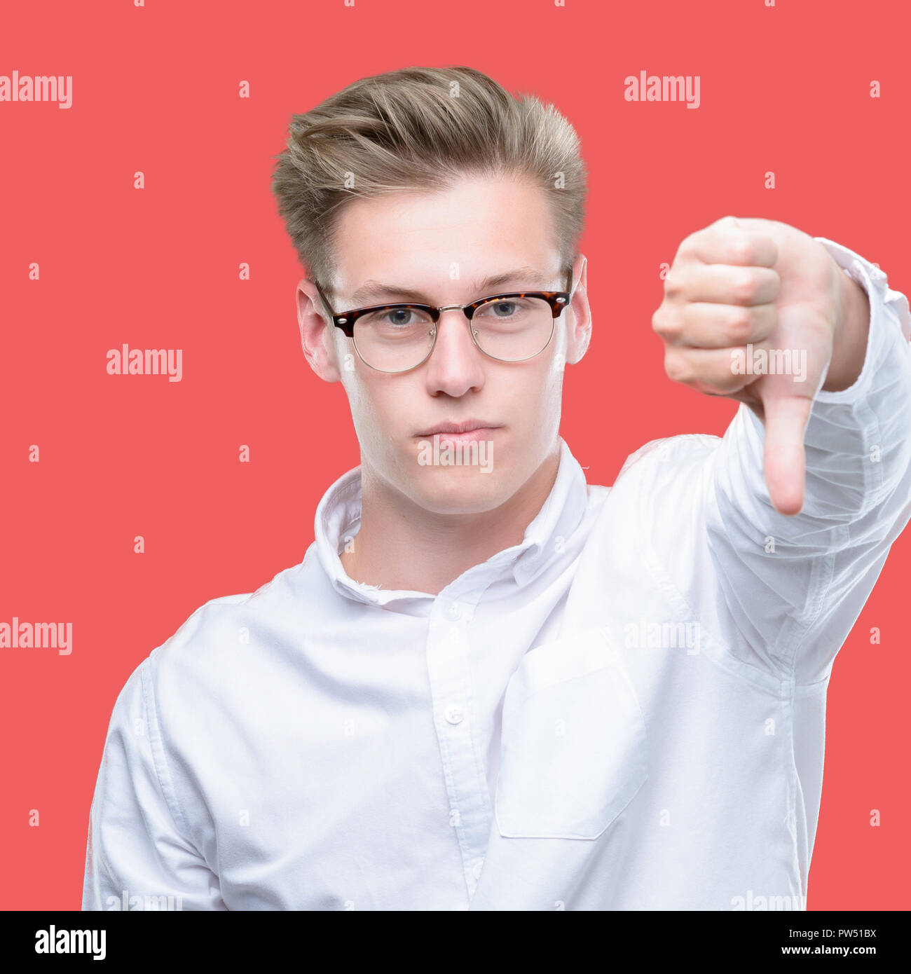 Young handsome blond man looking unhappy and angry showing rejection ...