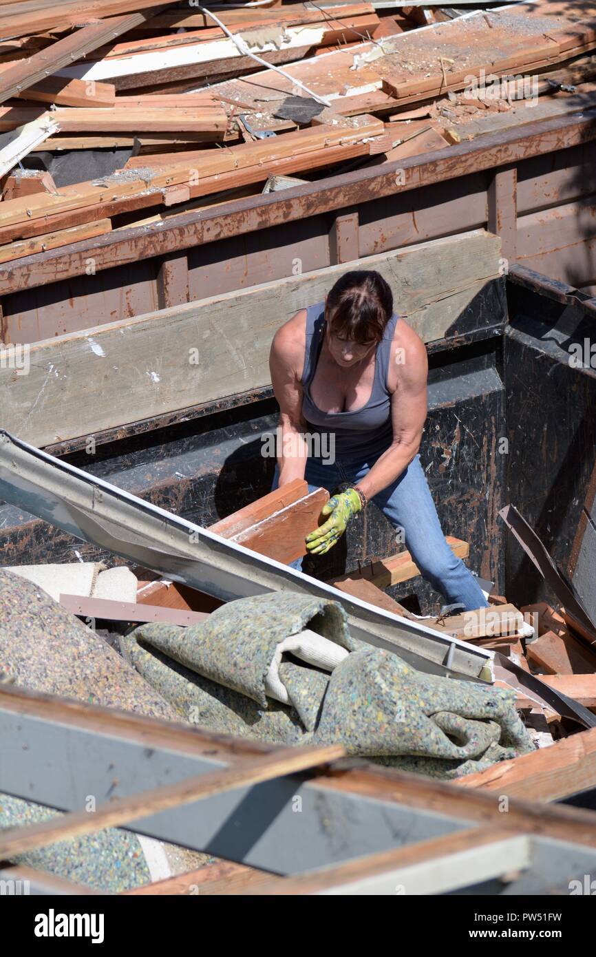 Woman salvaging lumber for reuse Stock Photo - Alamy