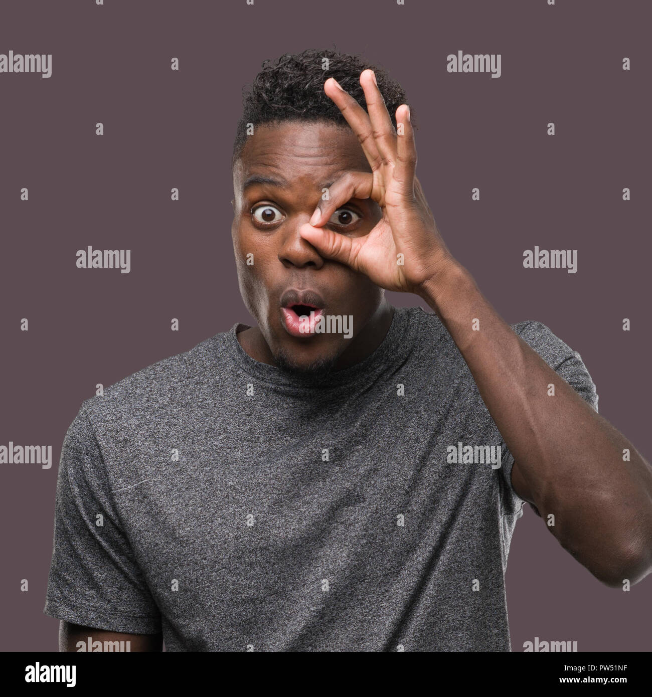 Young african american man wearing grey t-shirt doing ok gesture ...