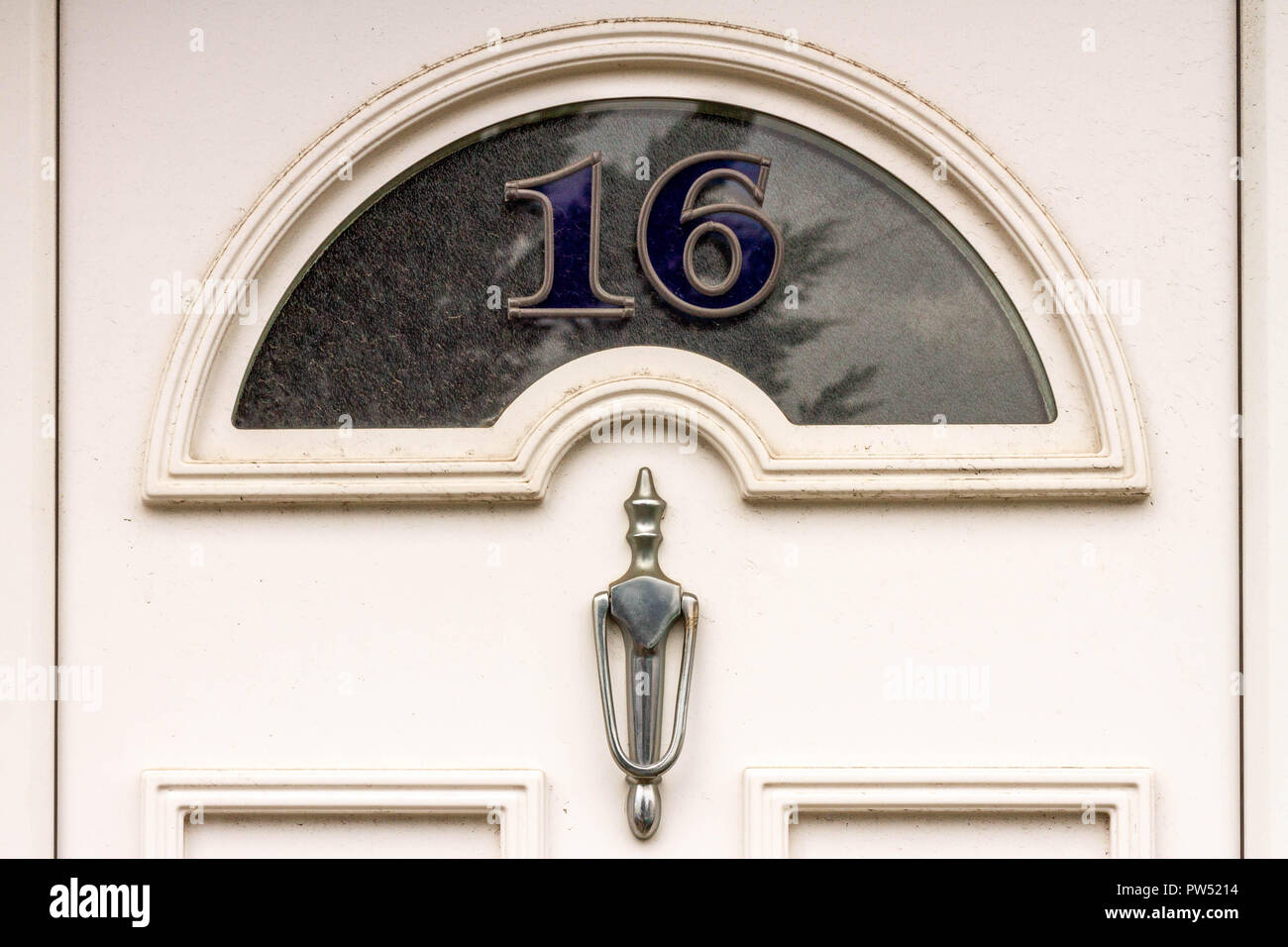 House number 16 with the sixteen in blue on a curved glass insert into ...
