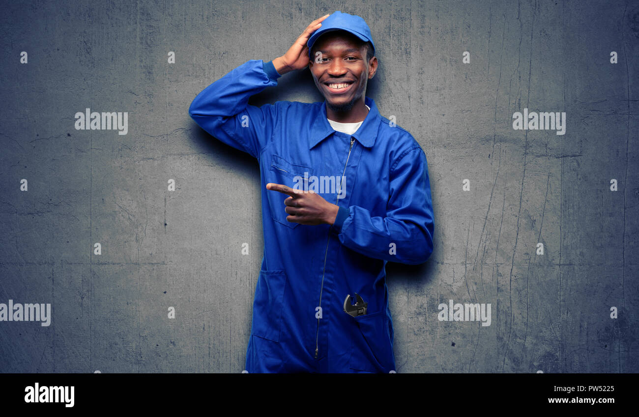 African black plumber man pointing away side with finger Stock Photo ...