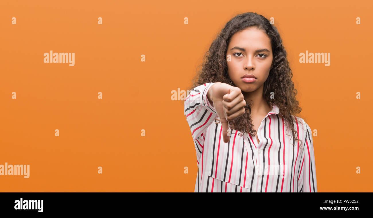 Beautiful young hispanic woman looking unhappy and angry showing ...