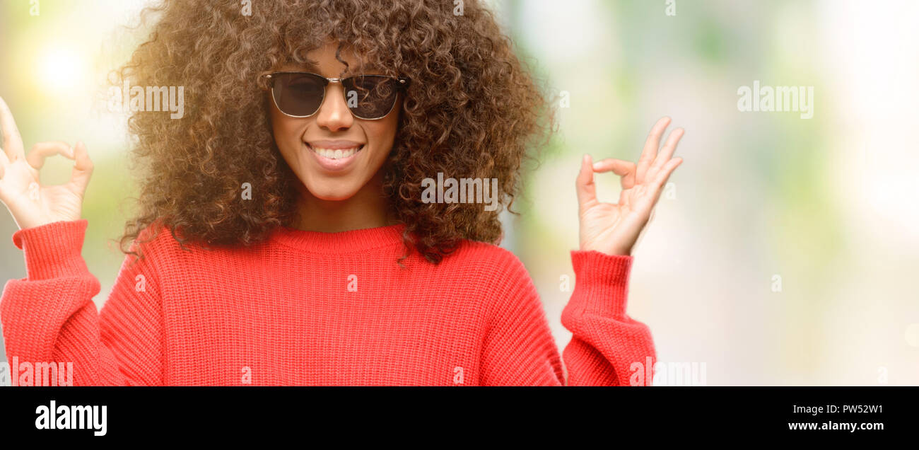 African american woman wearing sunglasses doing ok sign gesture with ...