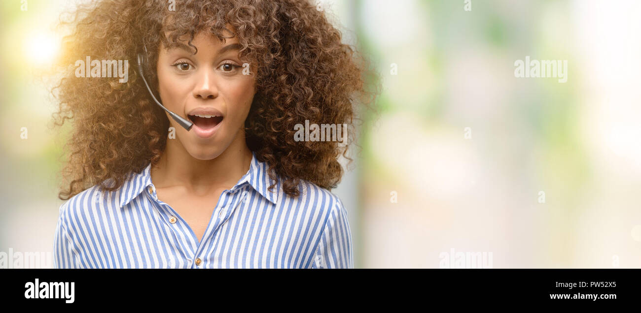 African american call center operator woman scared in shock with a ...