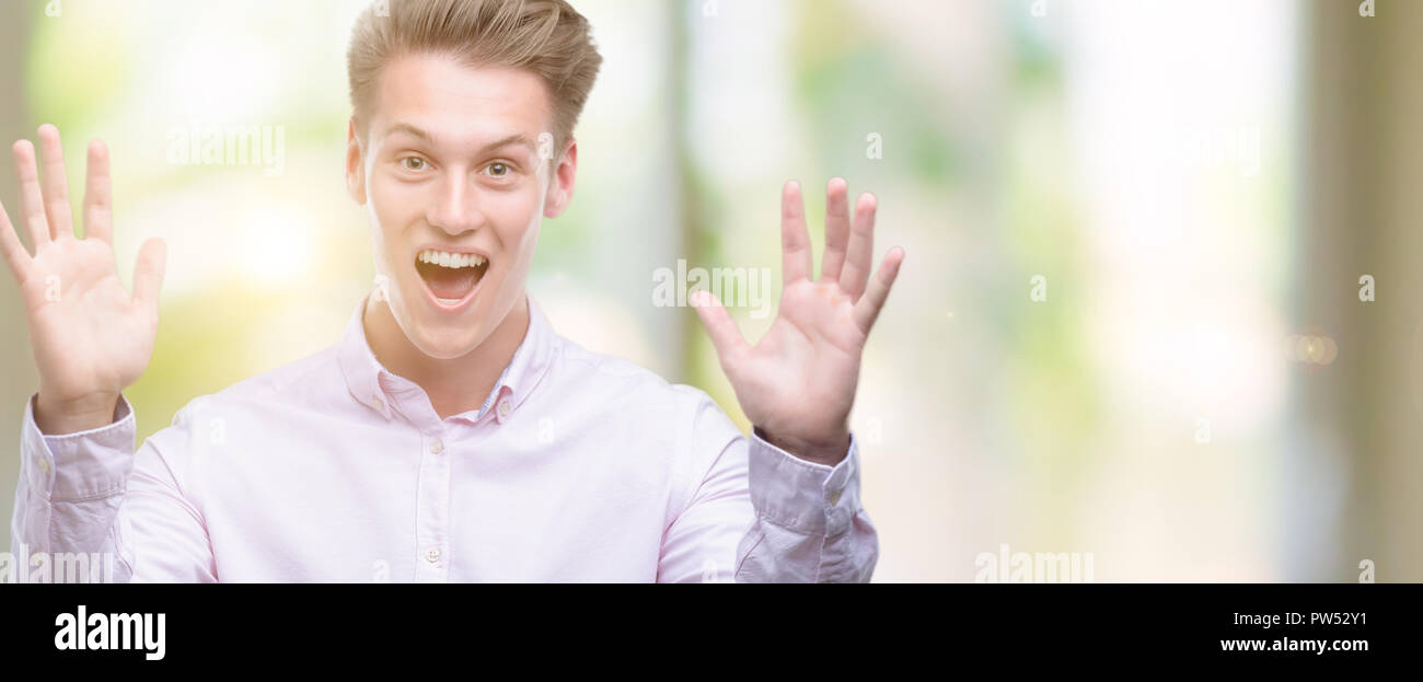 Young handsome blond man very happy and excited, winner expression ...