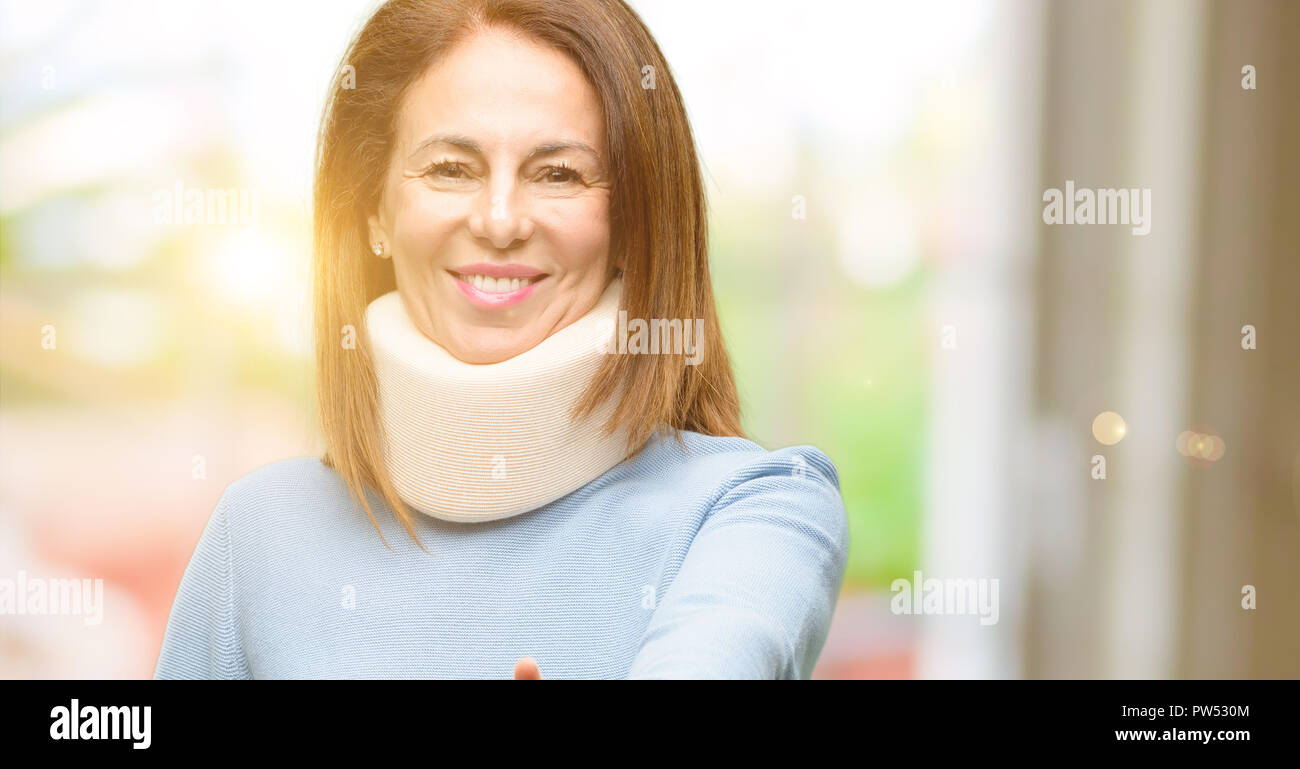 Injured woman wearing neck brace collar holds hands welcoming in ...