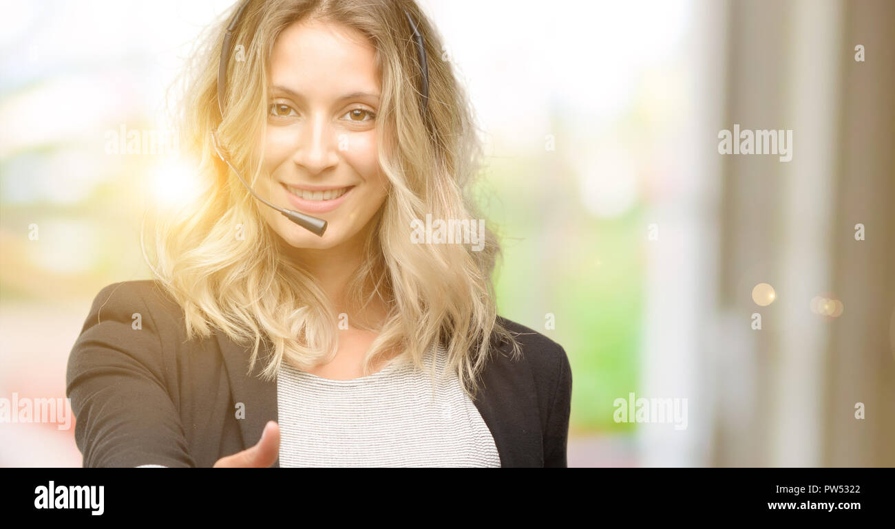 Young woman operator from call center holds hands welcoming in ...