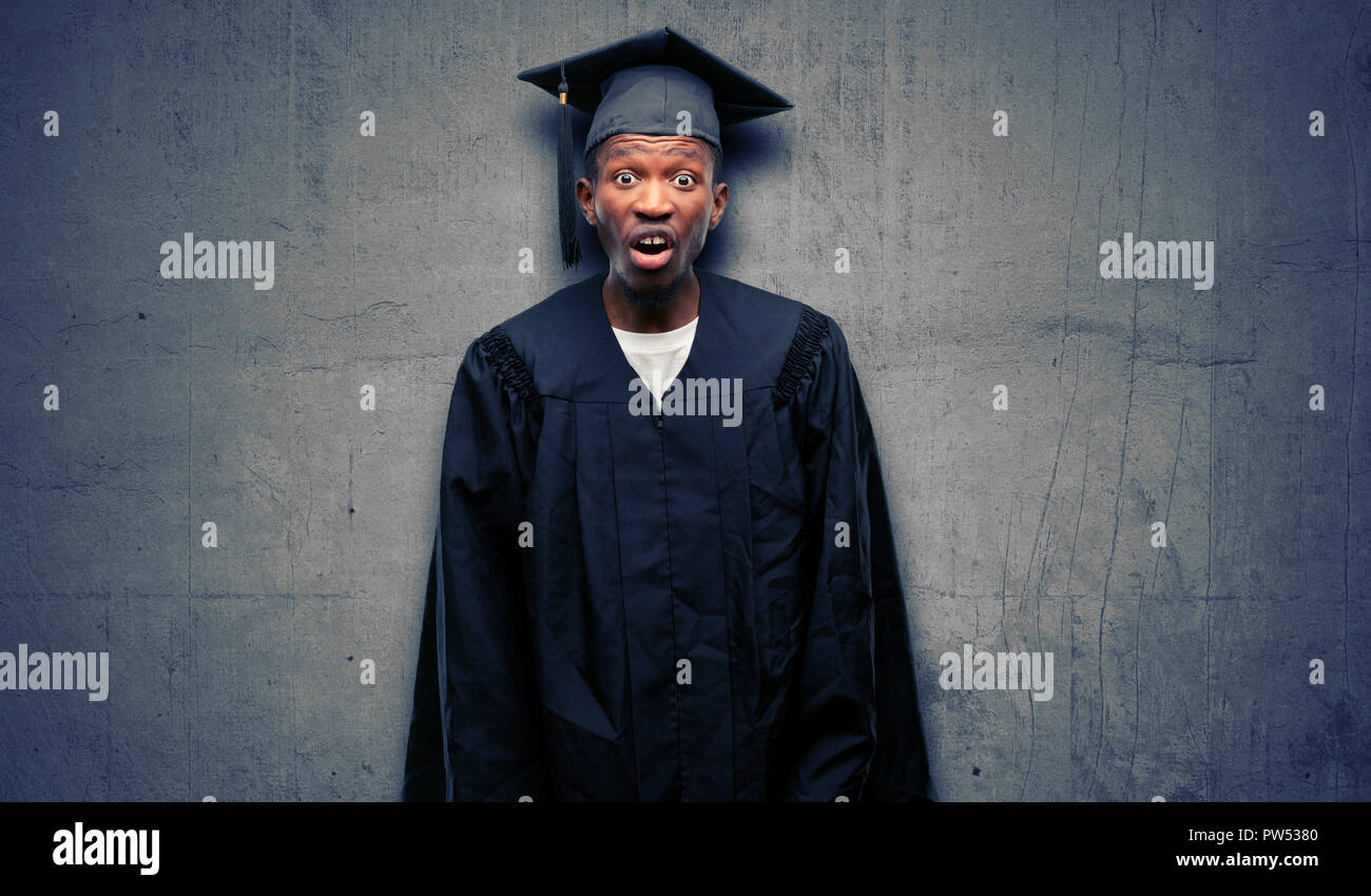 Young african graduate student black man scared in shock, expressing ...