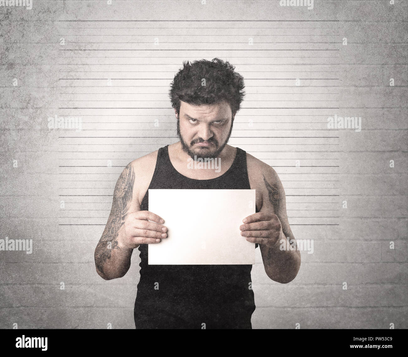 Gangster in front of a wall with table on his hand Stock Photo - Alamy