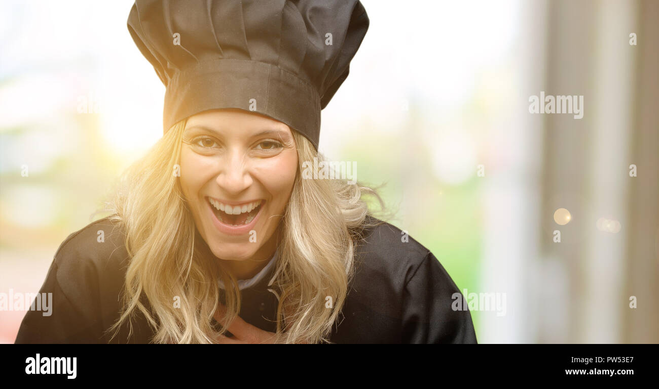 Beautiful cook woman chef confident and happy with a big natural smile ...