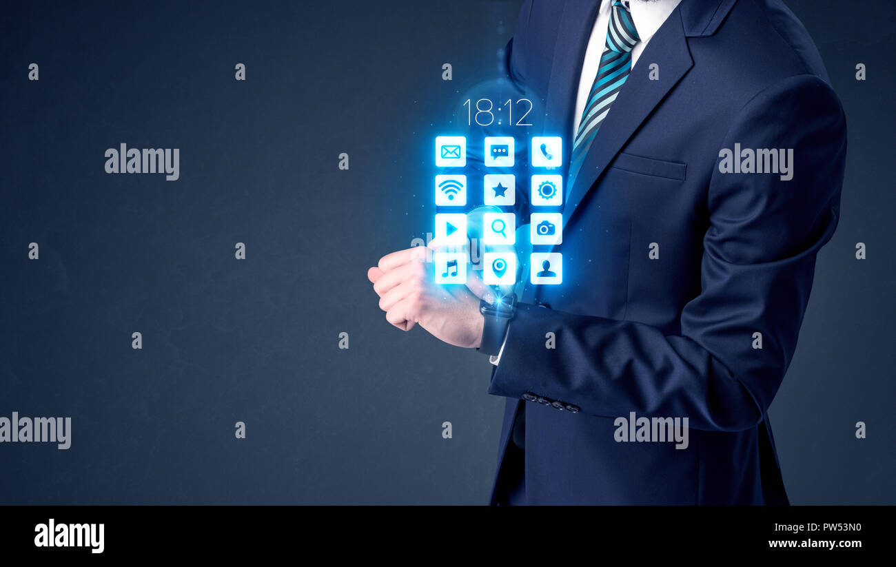 Businessman wearing smartwatch with application icons Stock Photo - Alamy