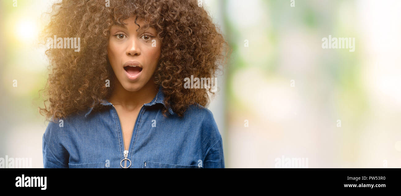 African american woman wearing blue jumpsuit scared in shock ...
