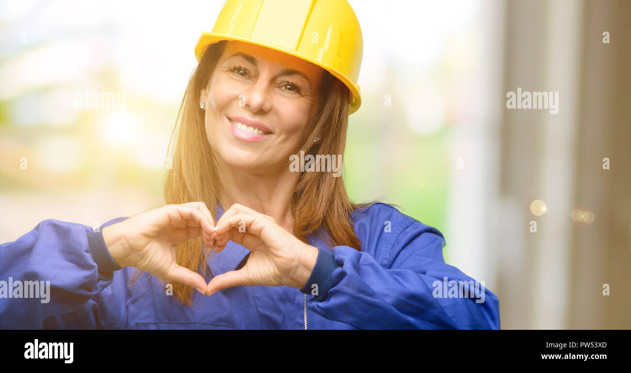 Engineer construction worker woman happy showing love with hands in ...