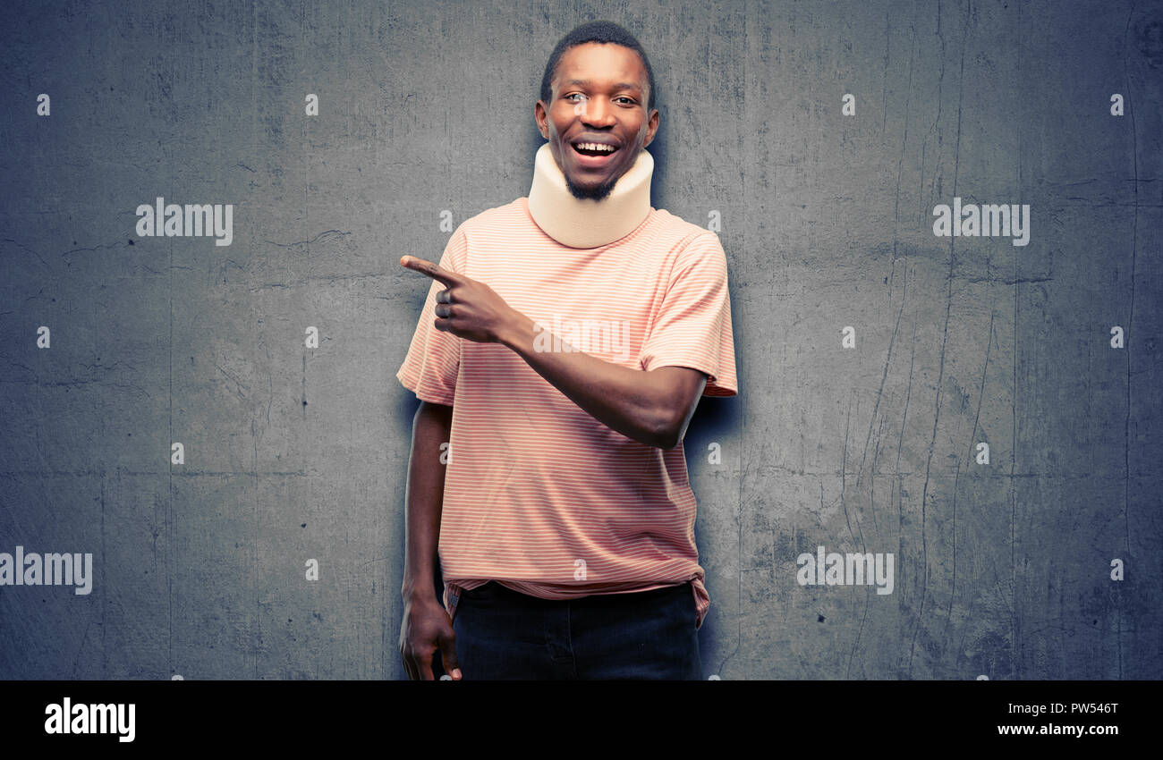 Injured african black man wearing neck brace pointing away side with ...