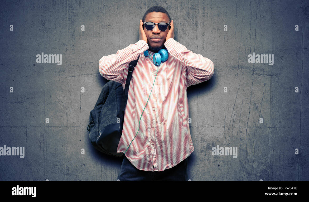 African black man student covering ears ignoring annoying loud noise ...