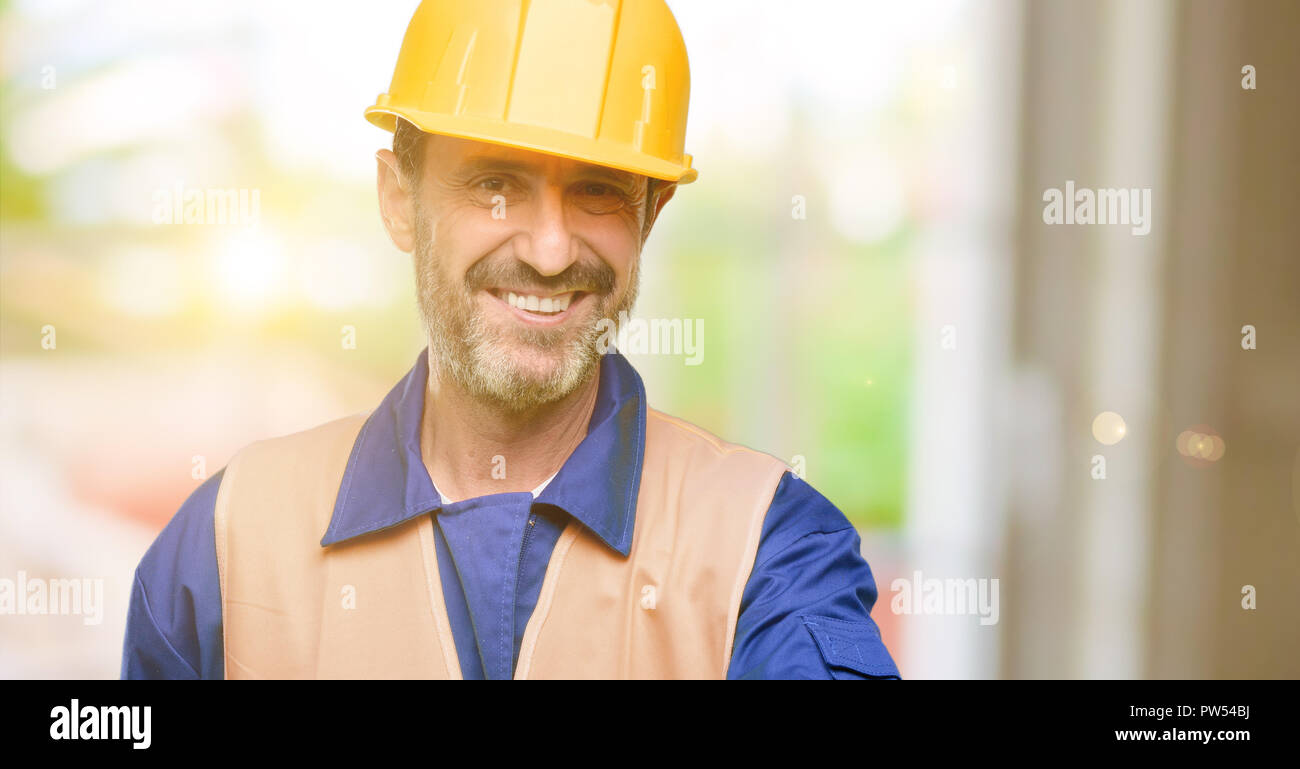 Senior engineer man, construction worker holds hands welcoming in ...