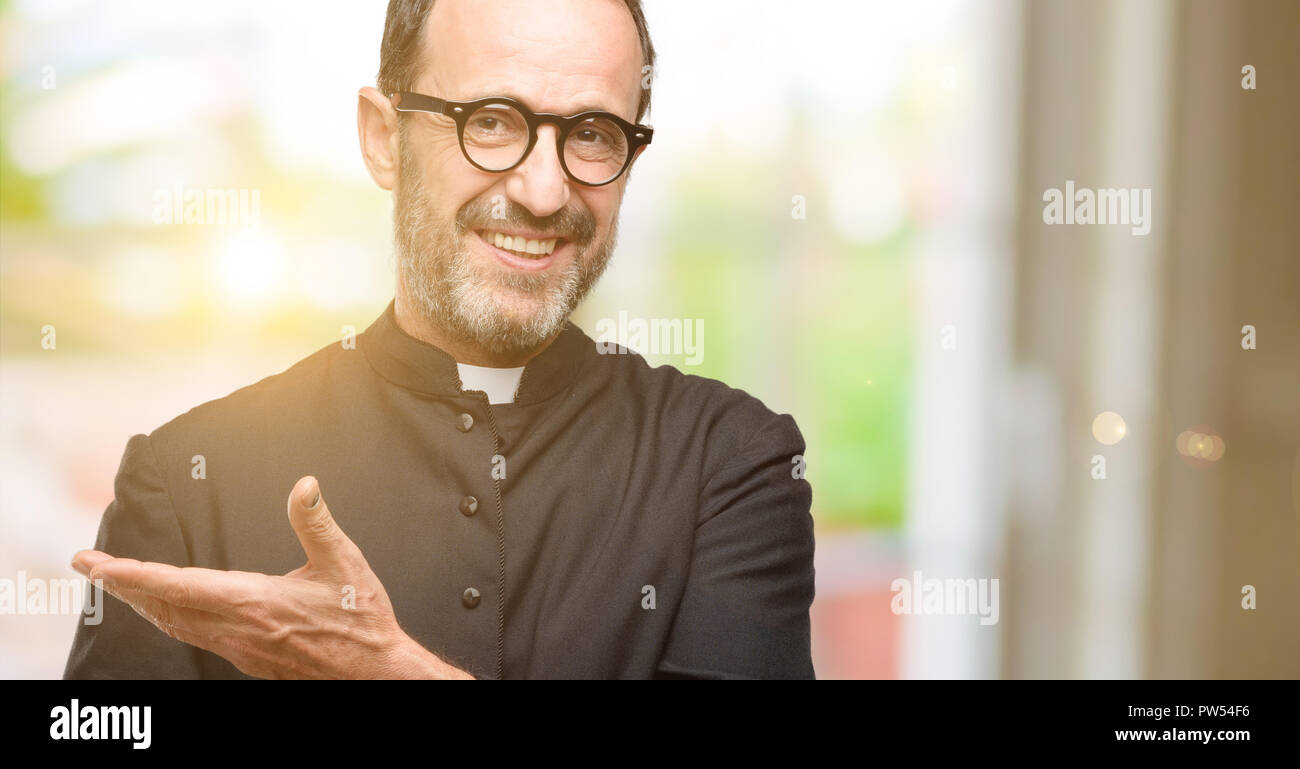 Priest religion man holding something in empty hand Stock Photo - Alamy
