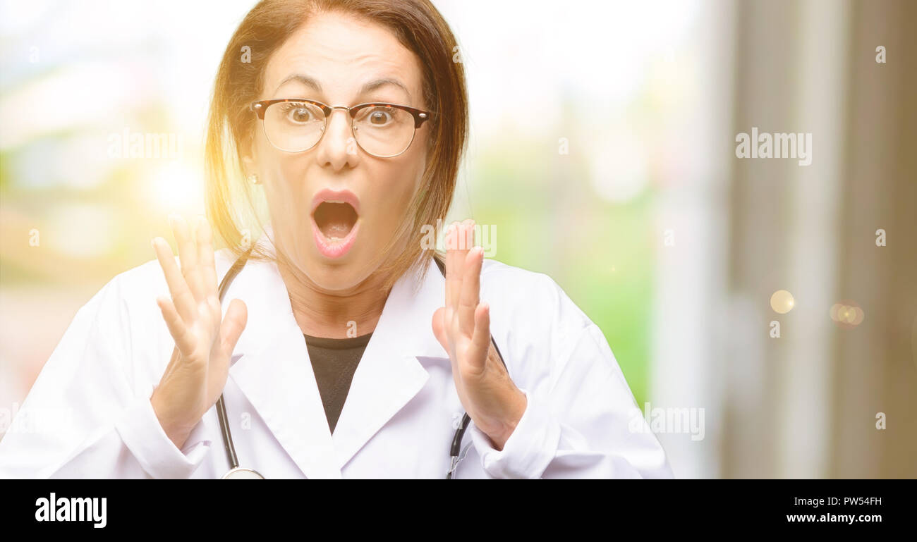 Doctor woman, medical professional stressful keeping hands on head ...