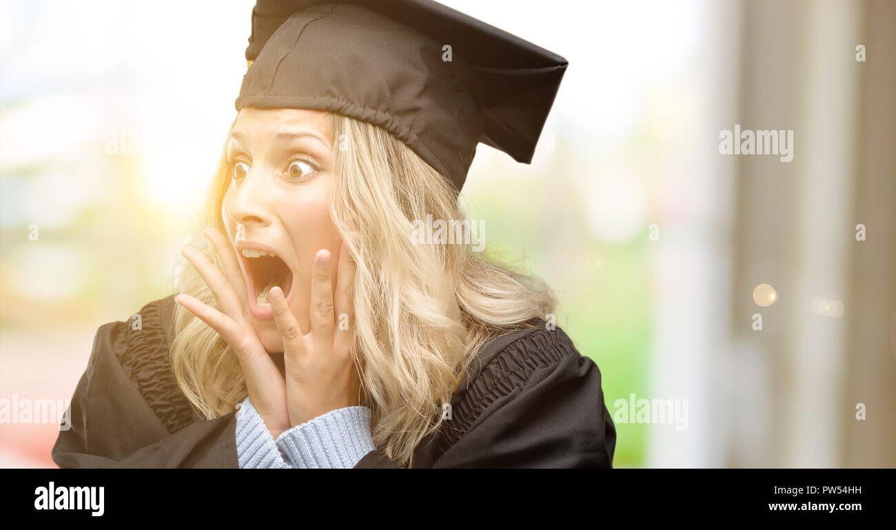 Young graduate woman stressful keeping hands on head, terrified in ...
