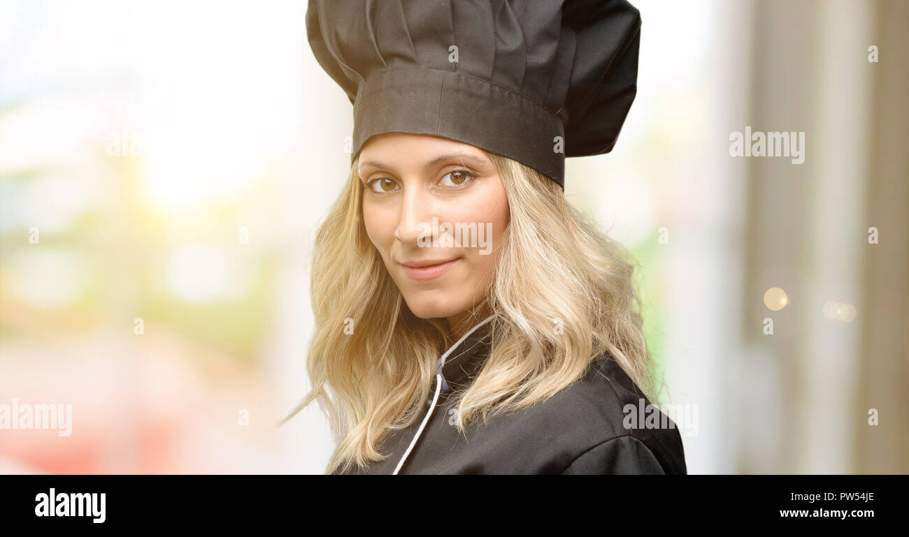 Beautiful cook woman chef confident and happy with a big natural smile ...