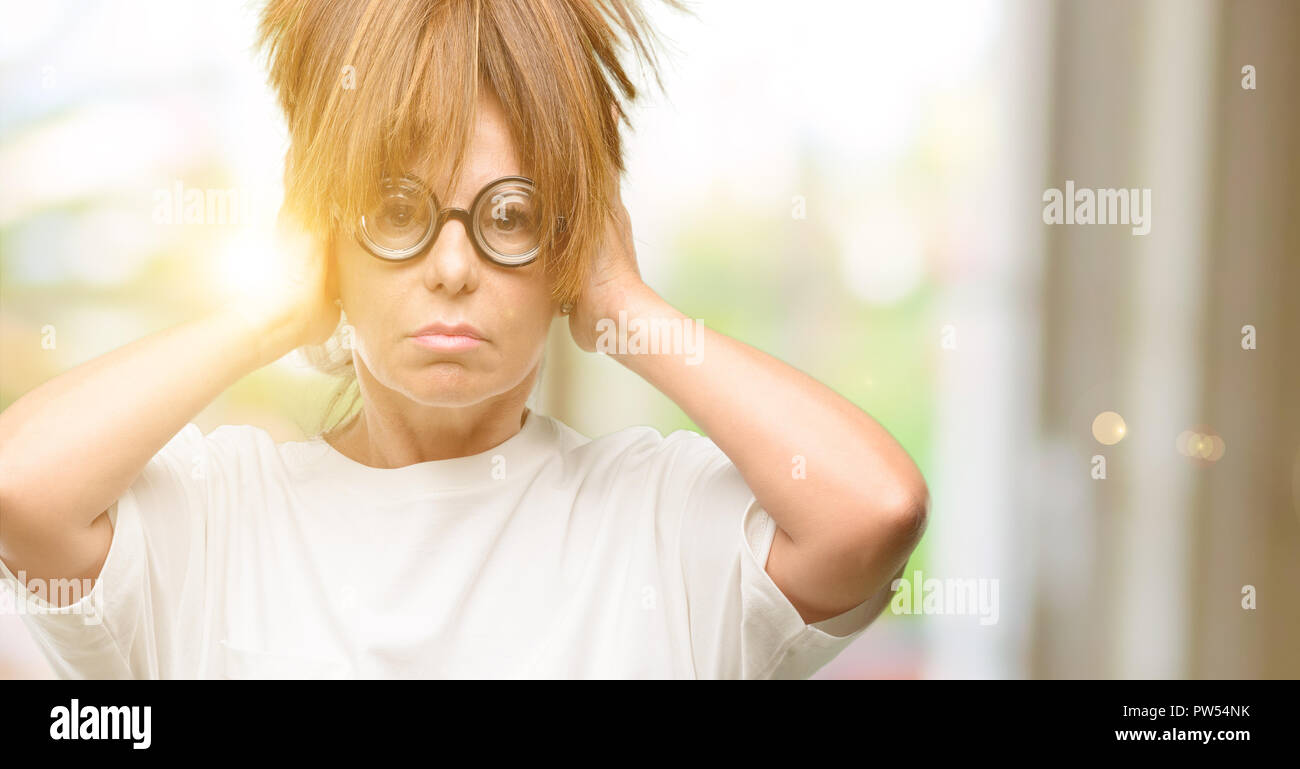 Crazy Middle Age Woman Wearing Silly Glasses Covering Ears Ignoring Annoying Loud Noise Plugs